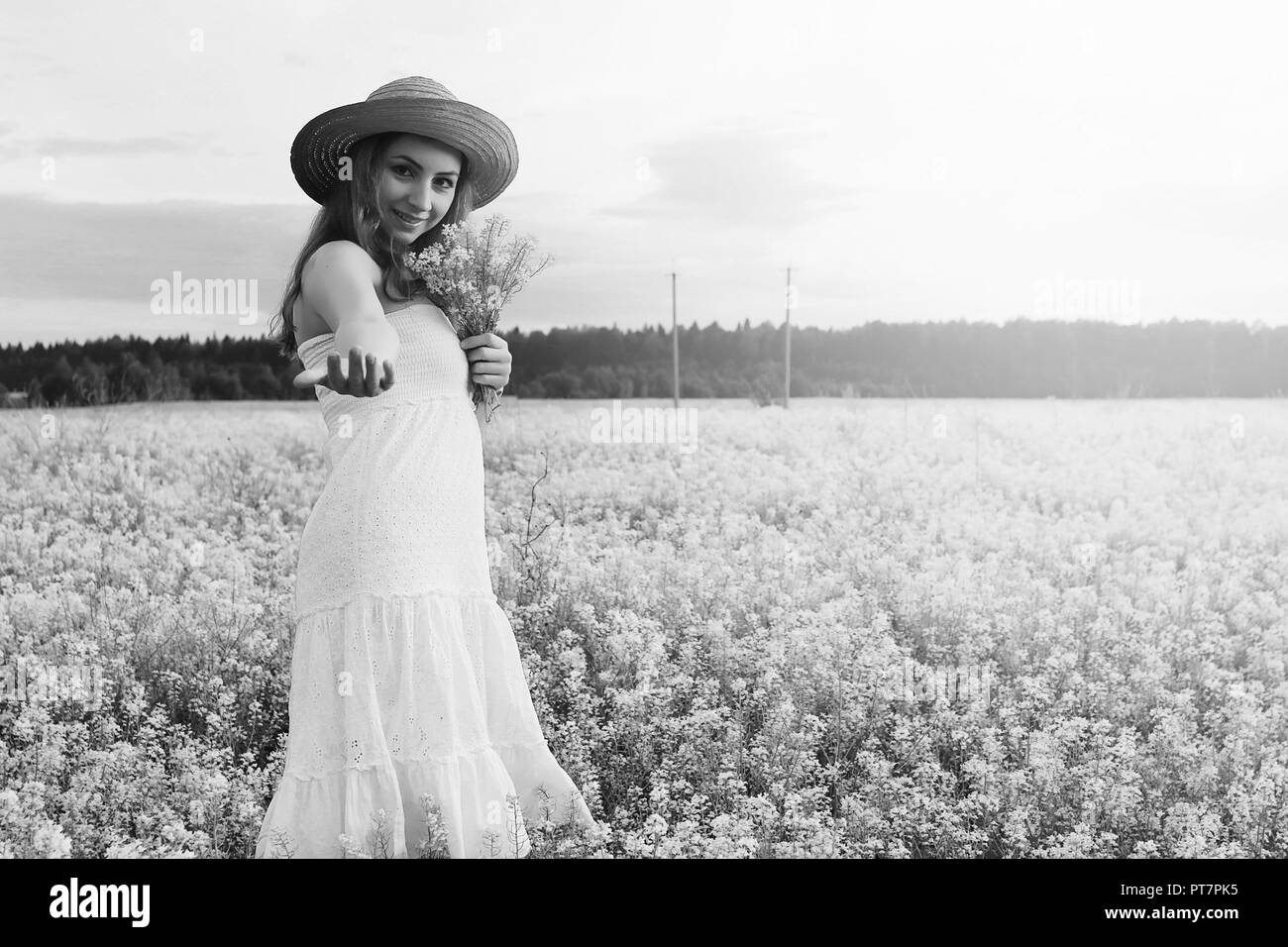 monochrome portrait of young girl in a hat standing in a huge fi Stock ...