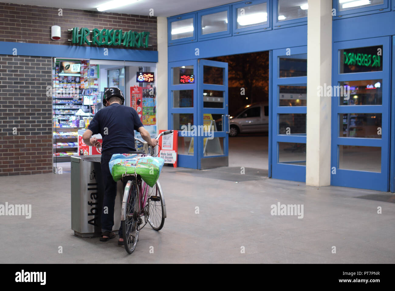 Berlin, Germany - September 10, 2018: Man digging in the trash can at S ...