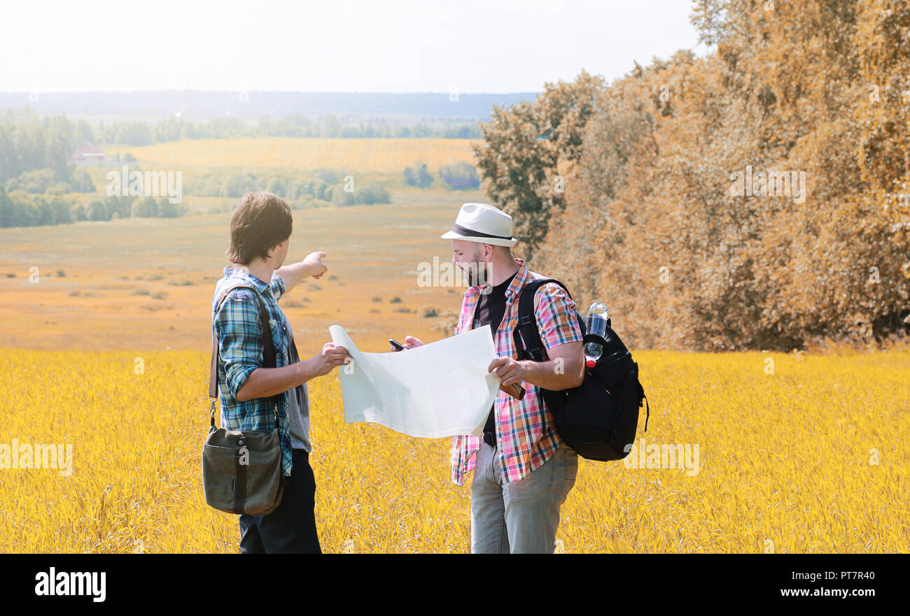 A young man looks at a map Stock Photo - Alamy