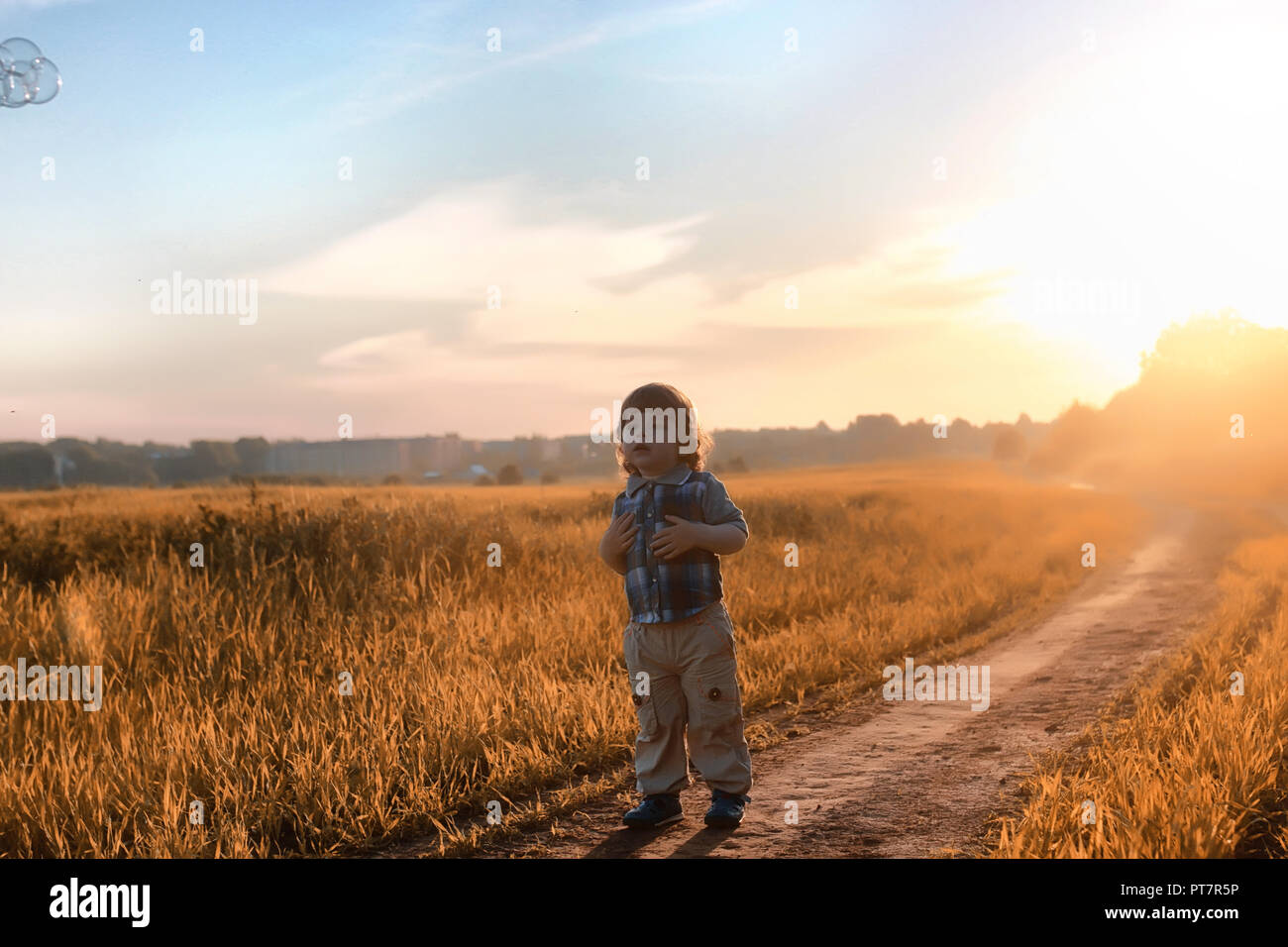 Children outdoors in a field Stock Photo - Alamy