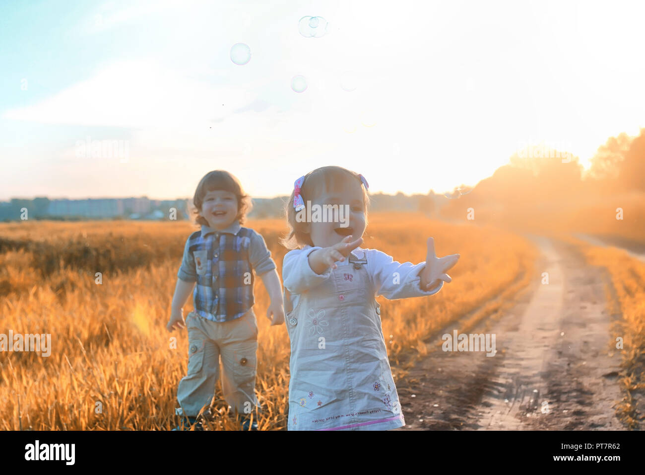 Children outdoors in a field Stock Photo - Alamy