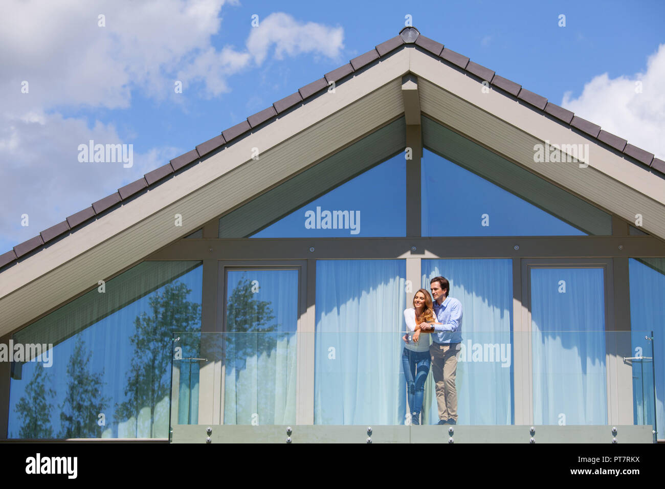Couple standing on the balcony hi-res stock photography and images - Alamy
