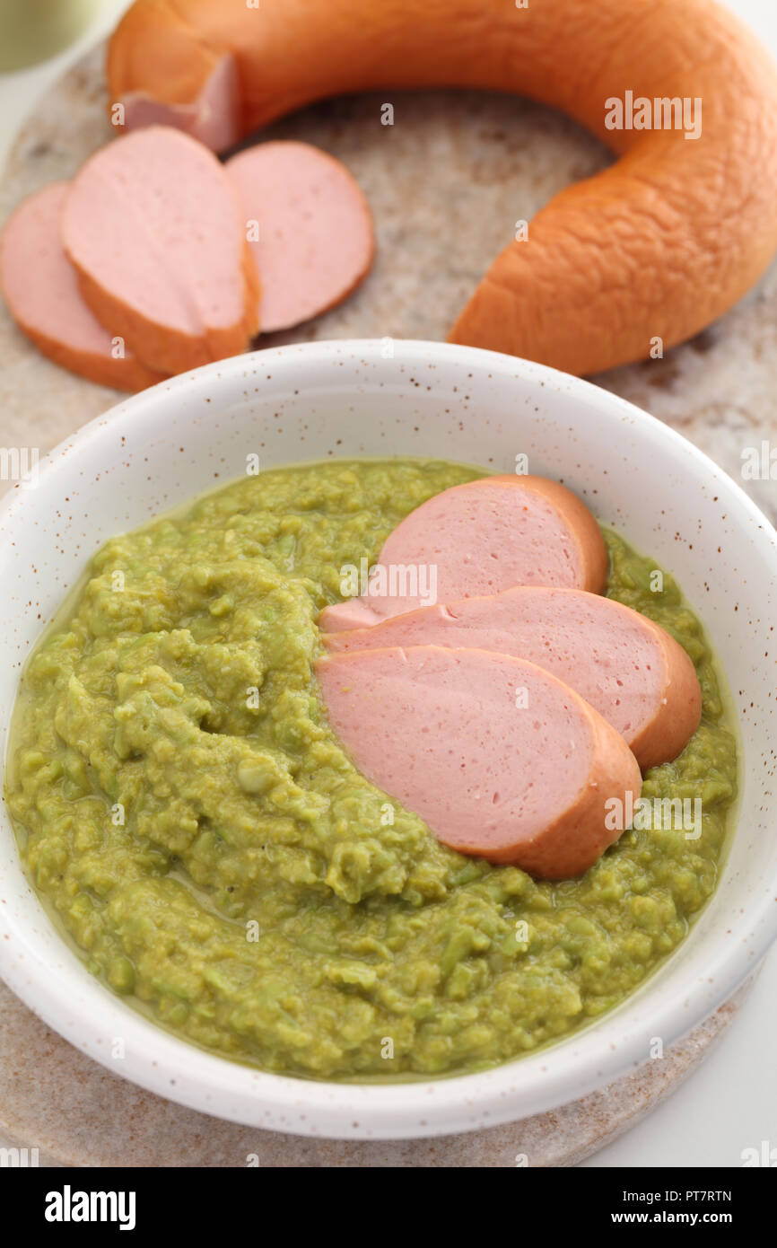 Traditional Dutch sausage Rookworst with pea mash on a rustic table ...