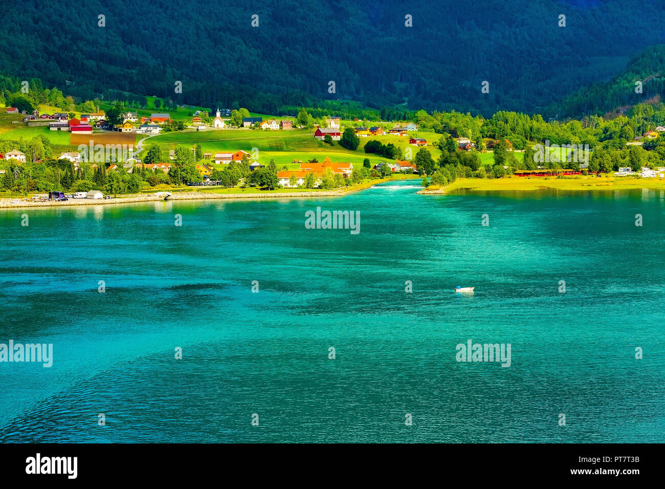 Norwegian village landscape with fjord, mountains and colorful houses ...