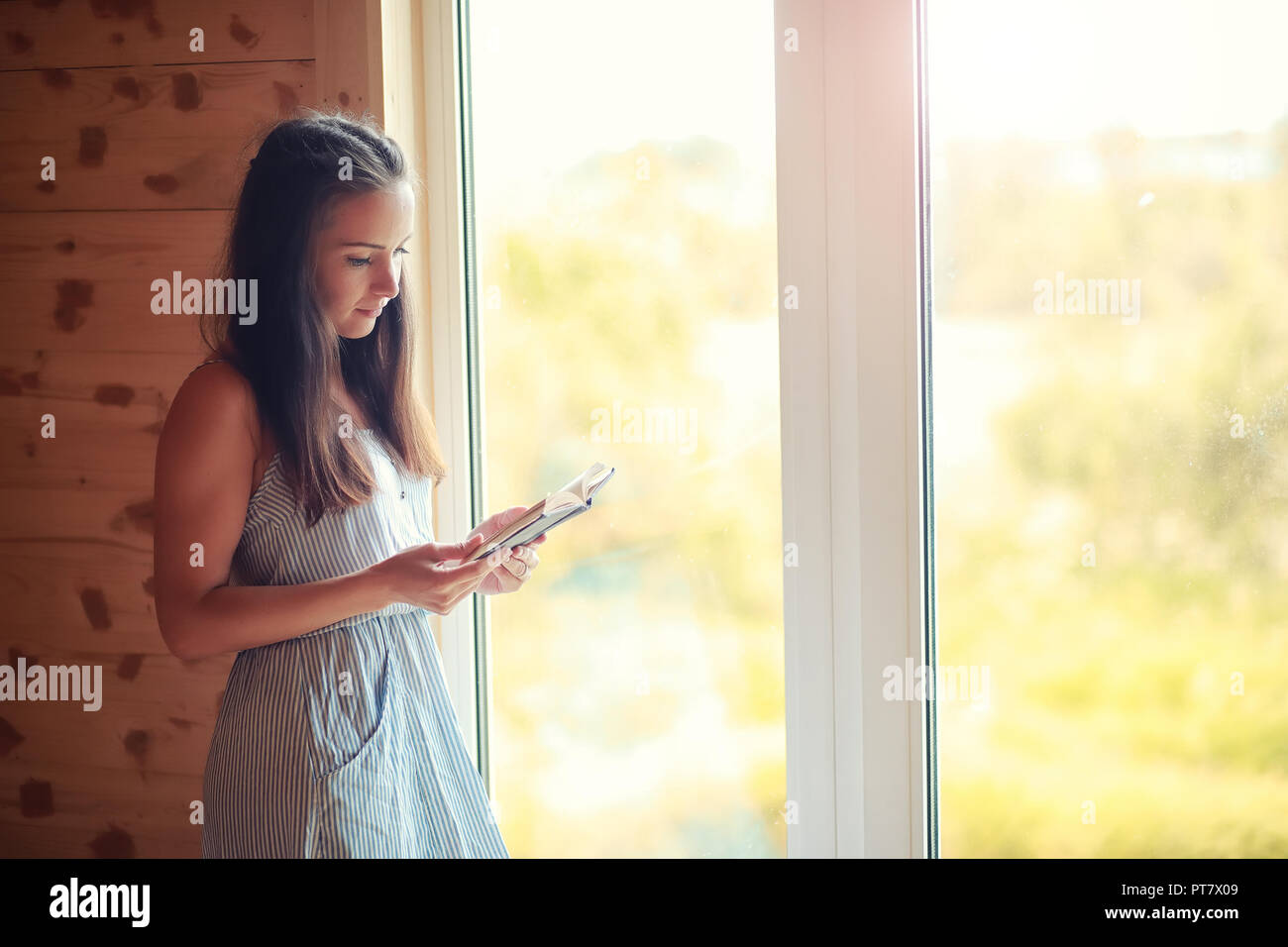 A girl at the window in the house Stock Photo - Alamy