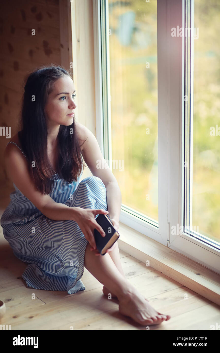 A girl at the window in the house Stock Photo - Alamy