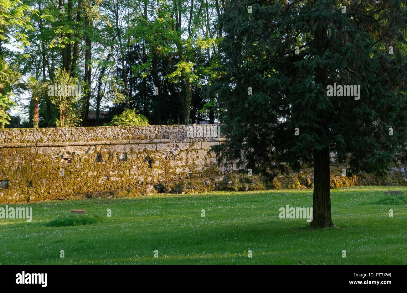 Ancient stone wall surrounding a city park Stock Photo - Alamy