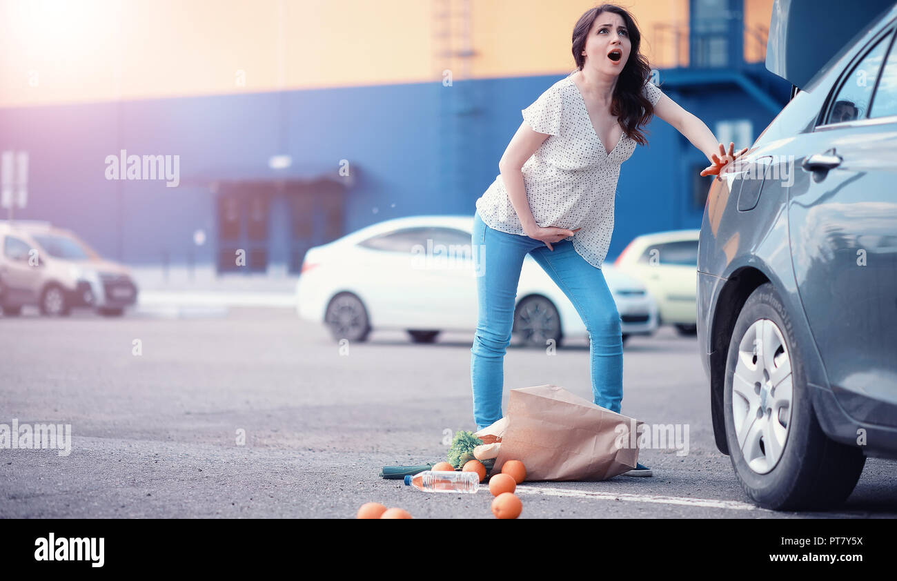 Girl with food coming out of the grocery store Stock Photo - Alamy