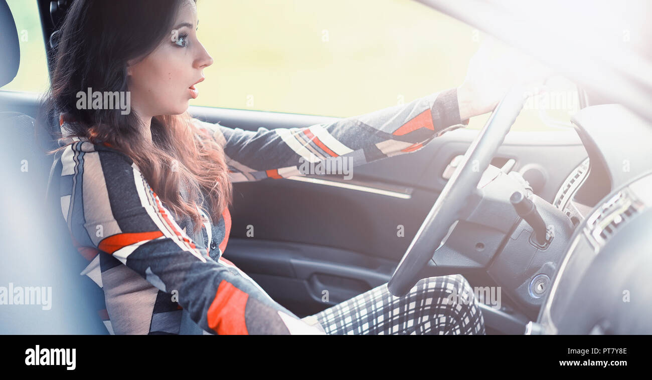 Girl driving a car bad emotions Stock Photo - Alamy