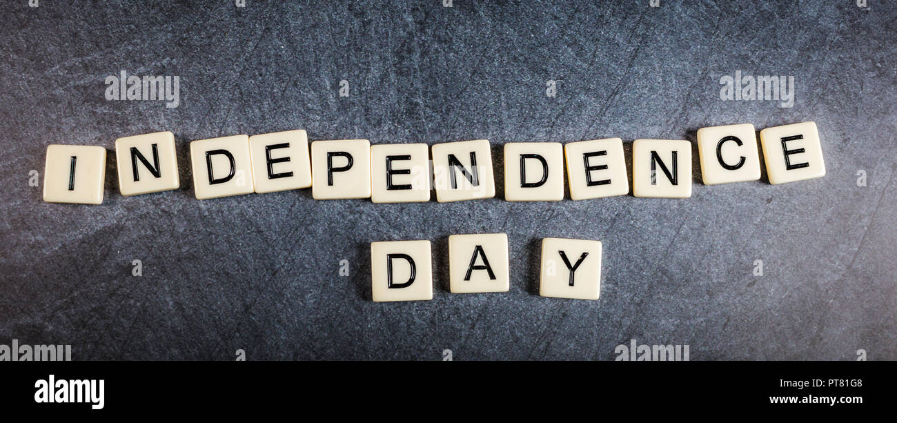 Letter tiles on black slate background spelling Independence day Stock ...