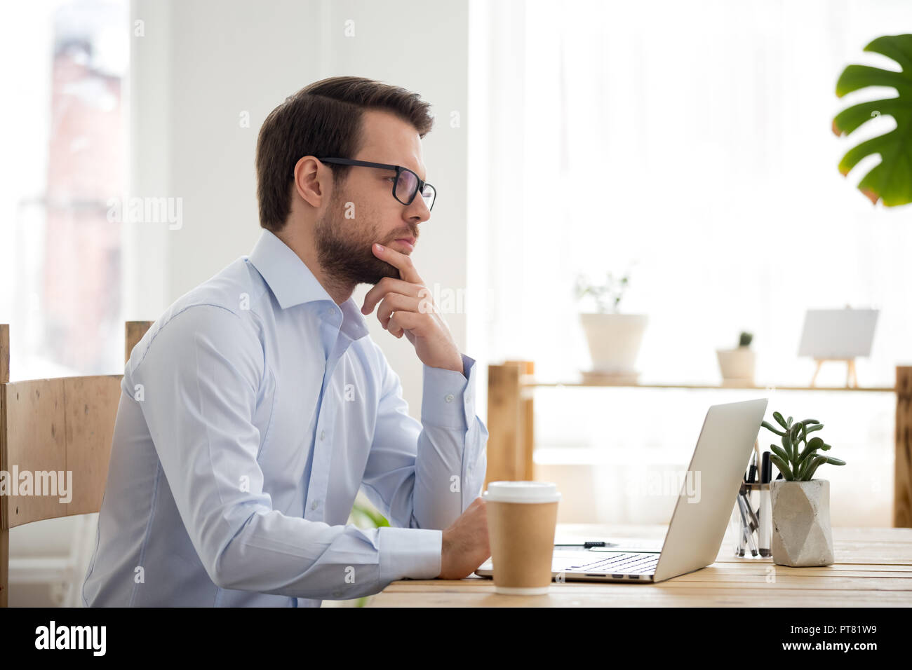 Confident businessman sitting desk office thinking hi-res stock ...