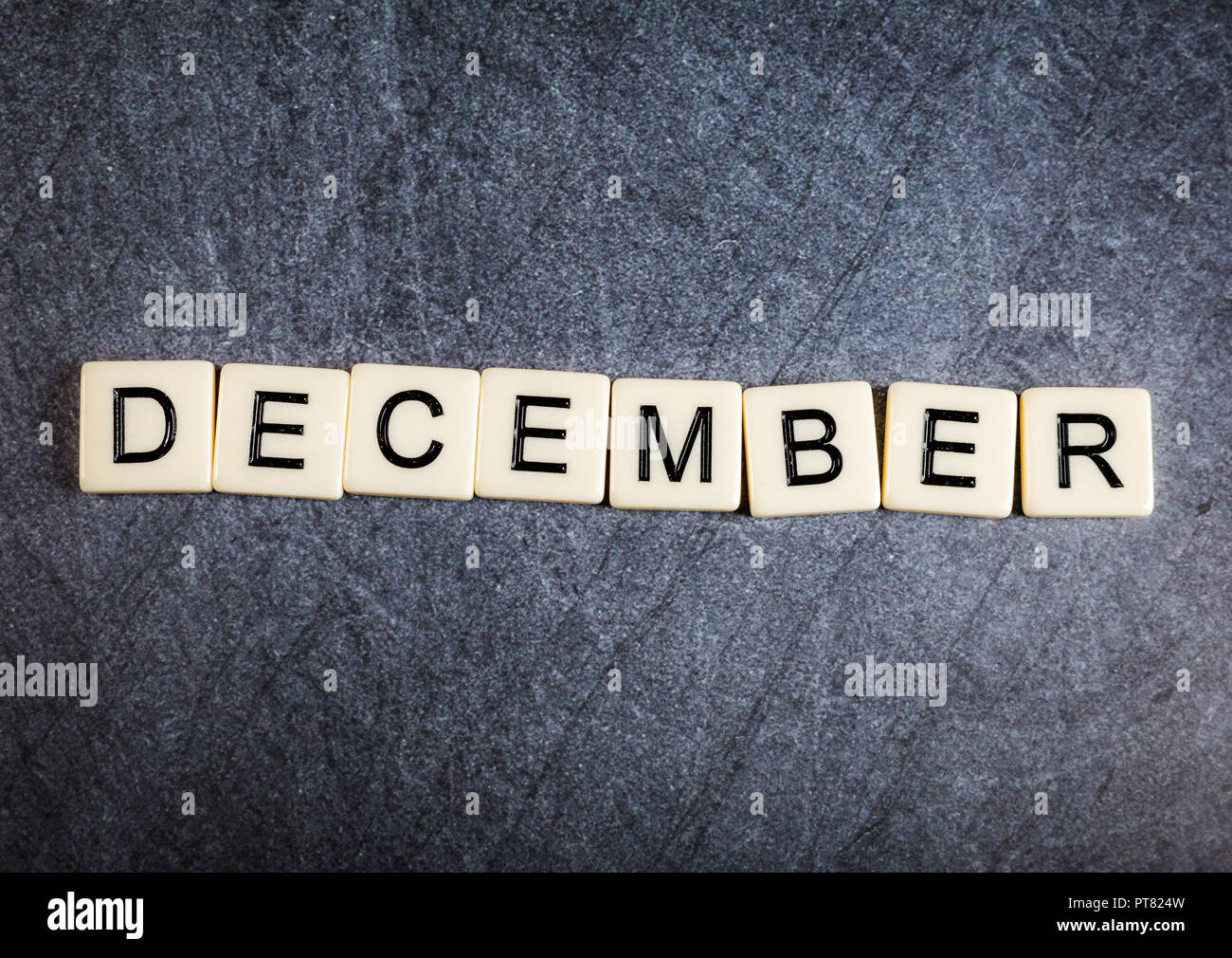 Letter tiles on black slate background spelling December Stock Photo ...