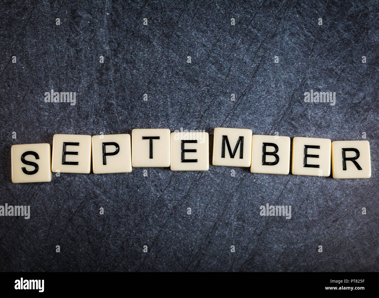 Letter tiles on black slate background spelling September Stock Photo ...