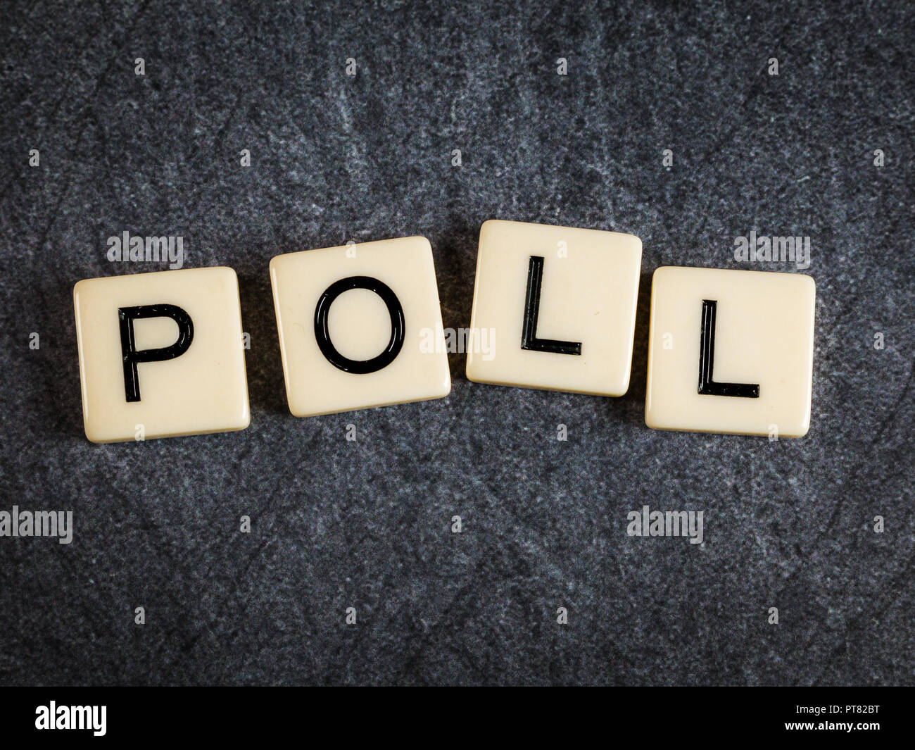 Letter tiles on black slate background spelling Poll Stock Photo - Alamy