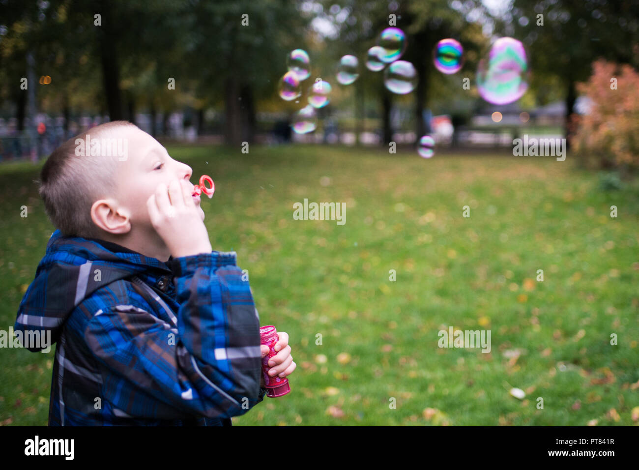 Beautiful boy blowing soap bubbles hi-res stock photography and images ...
