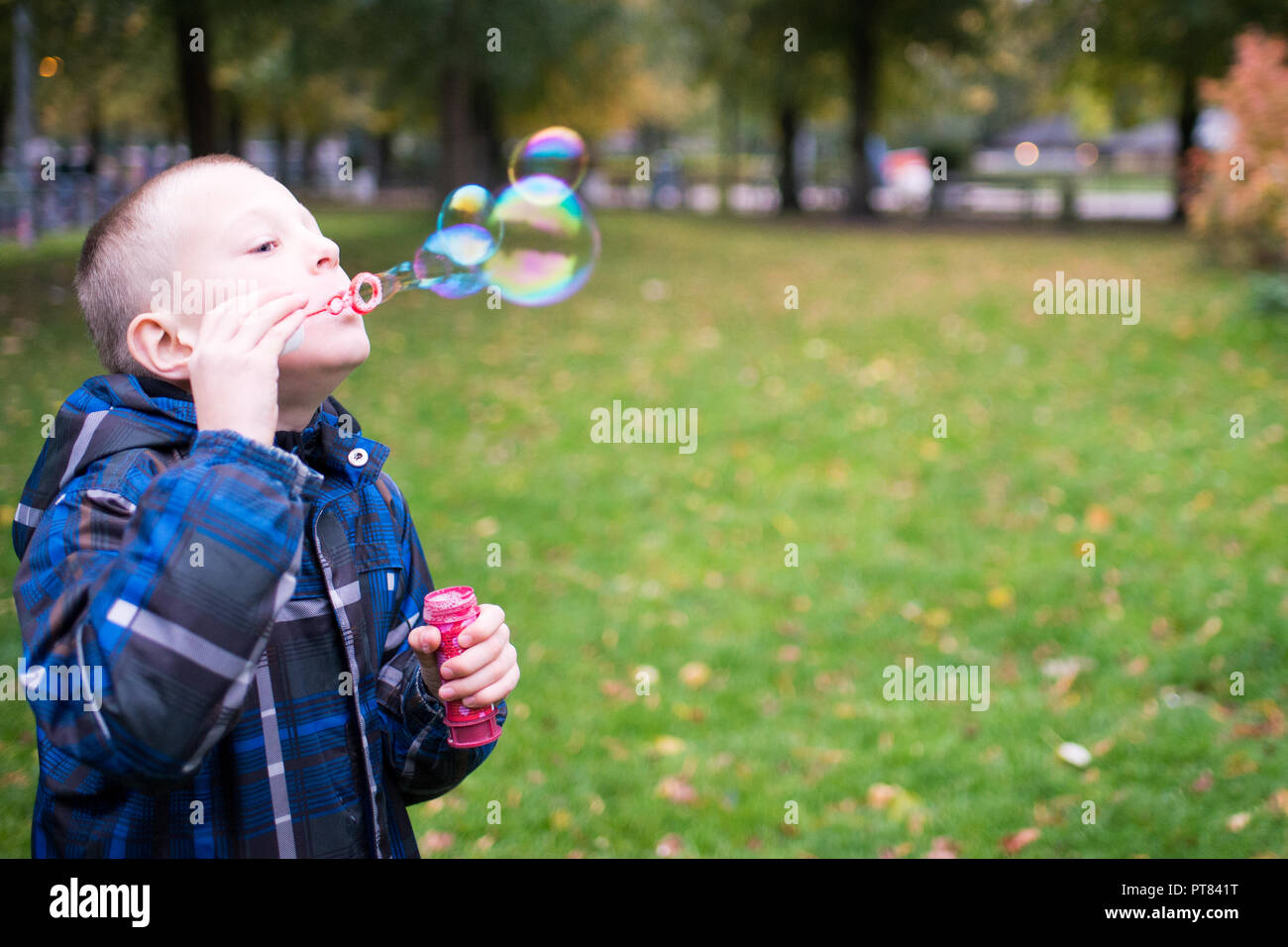Beautiful boy blowing soap bubbles hi-res stock photography and images ...