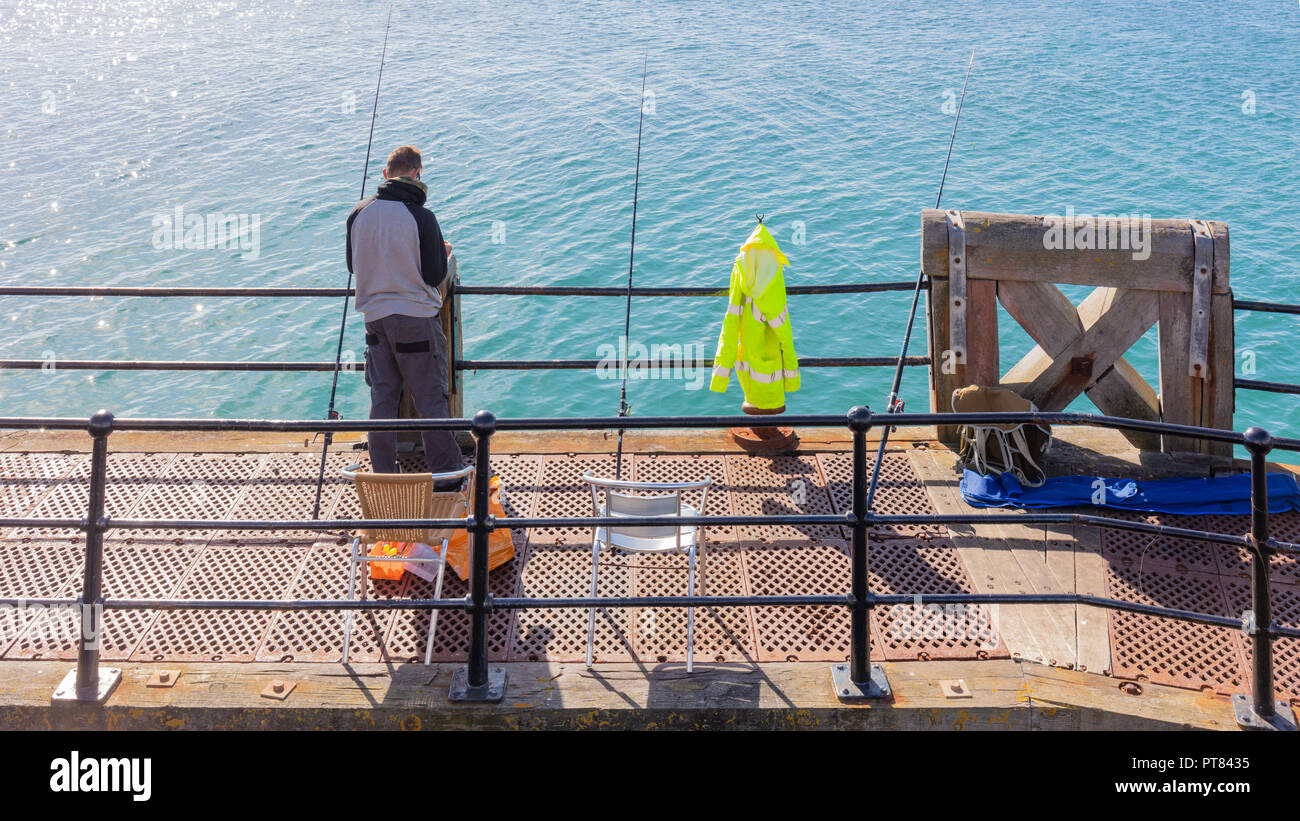 Rear View of Man Fishing in the Sea Stock Photo - Alamy