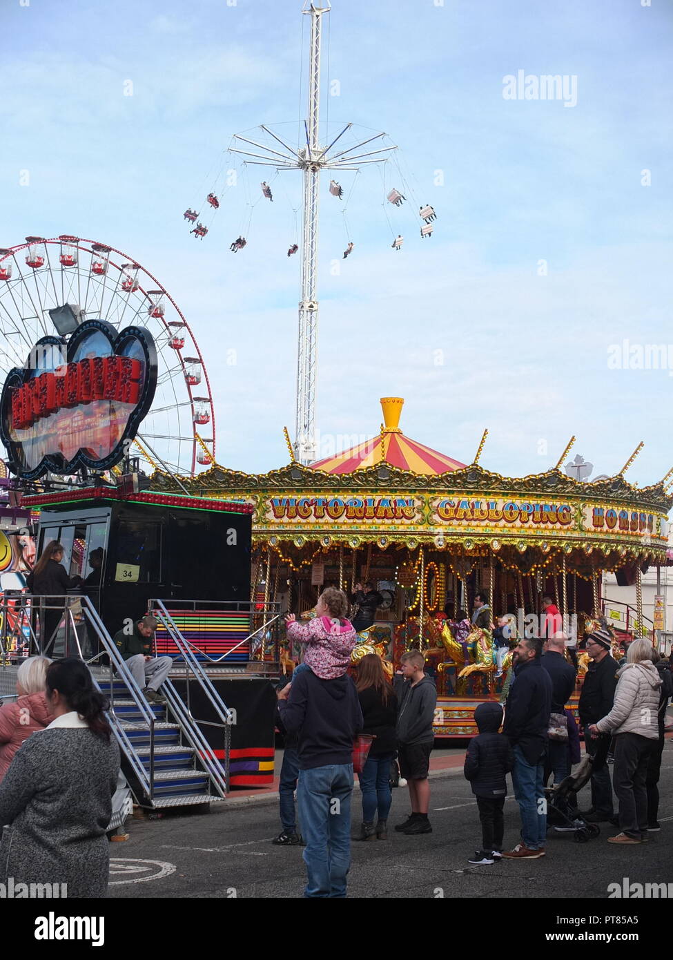 General perspective of Nottingham Goose Fair showing rides including a ...
