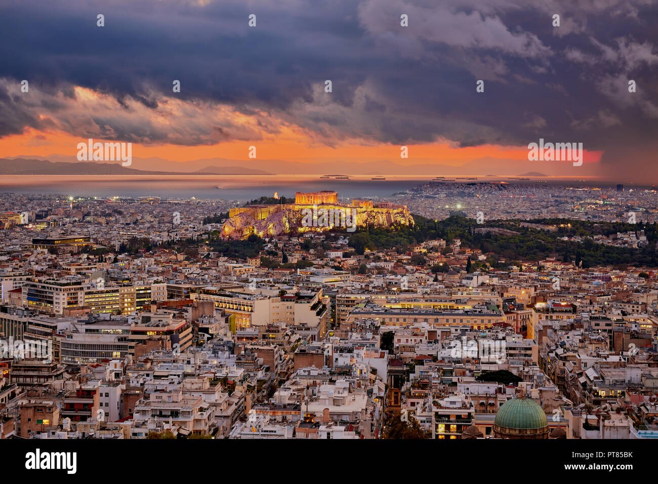 Illuminated Acropolis of Athens Greece at cloudy sky sunset with the ...