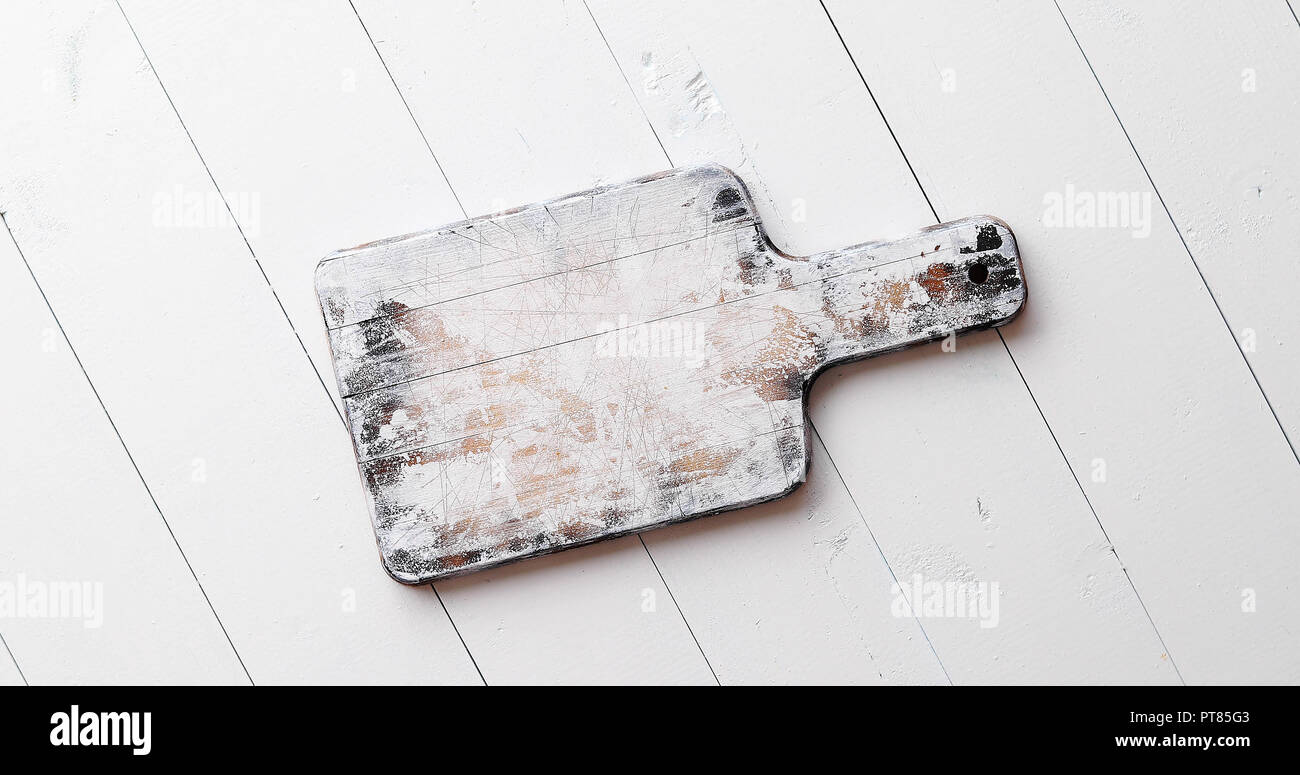 Wooden chopping board on white board table Stock Photo - Alamy