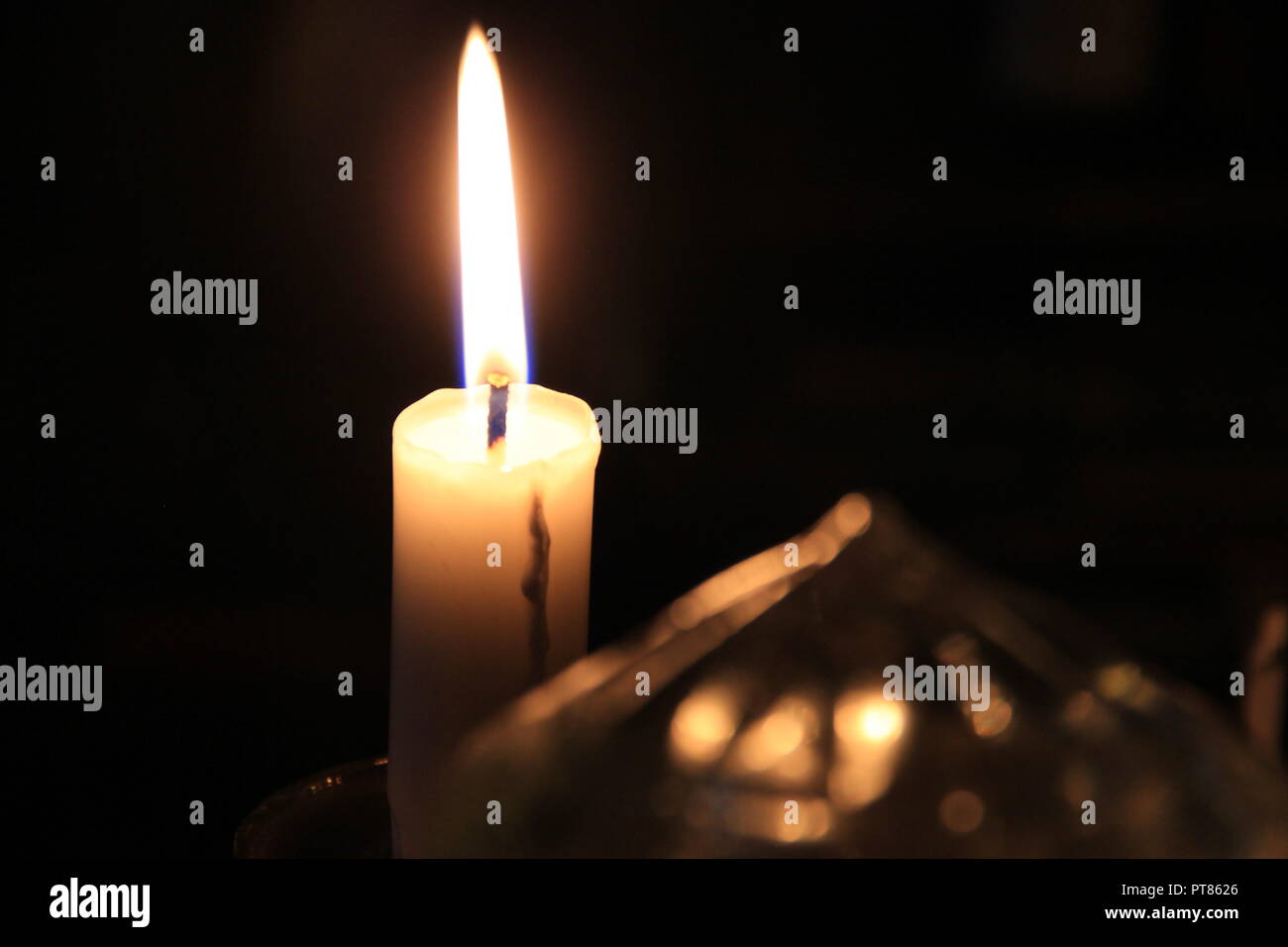 Candle against dark background Stock Photo - Alamy
