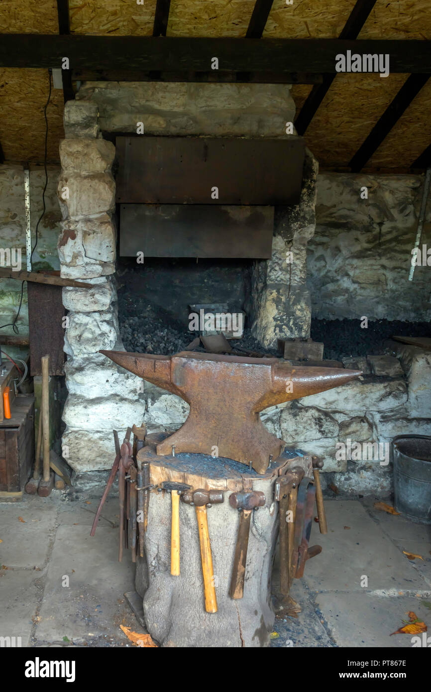 Blacksmiths workshop showing the forge anvil and assorted hammers at ...