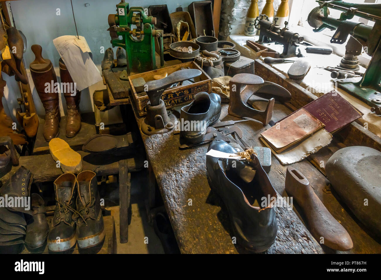 Clogmakers workshop showing the workbench with several anvils tools and ...