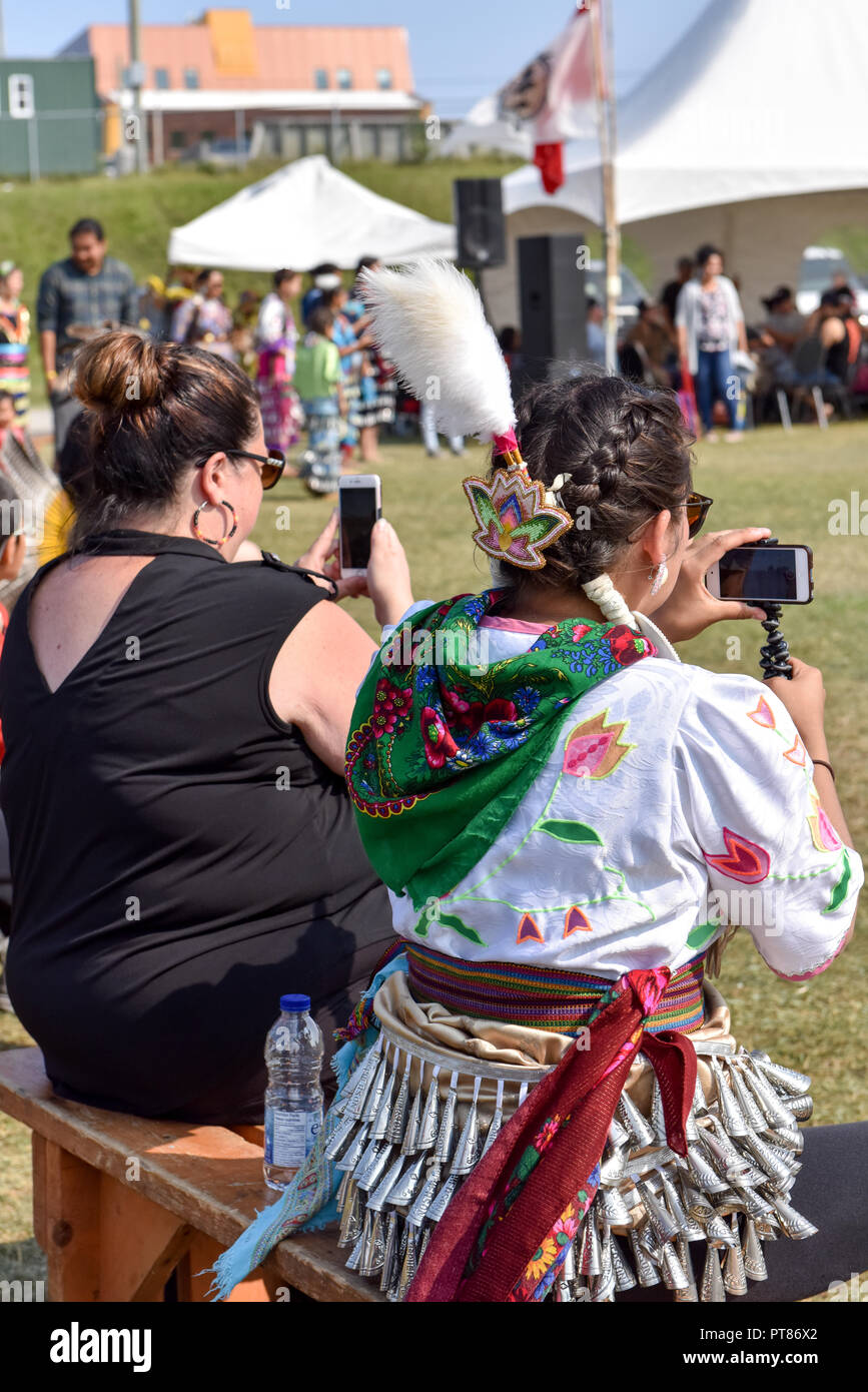 First Nations women taking photographs during Pow Wow celebration ...
