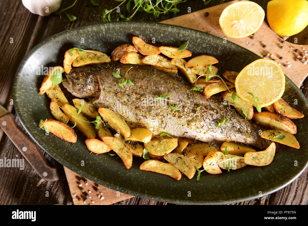 Roasted trout with potatoes in thyme Stock Photo - Alamy