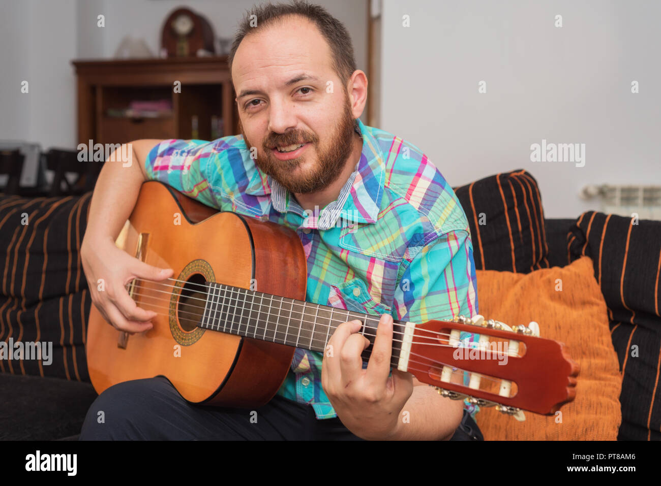 Young man musician playing acoustic guitar Stock Photo - Alamy