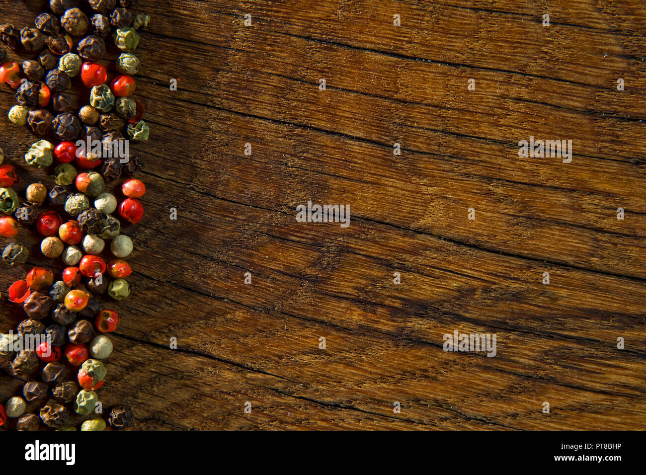 Top view of colour pepper on wooden desk and black table background ...