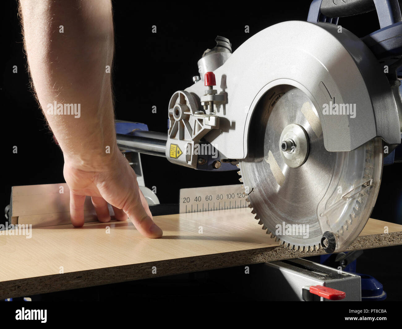 Carpenter cutting flaxboard using sliding compound mitre saw Stock ...