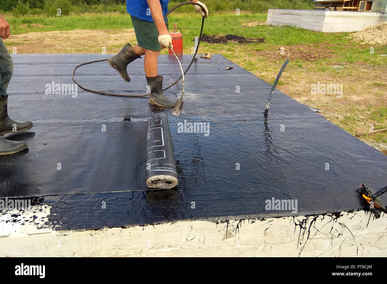 Professional installation of waterproofing on the concrete foundation ...