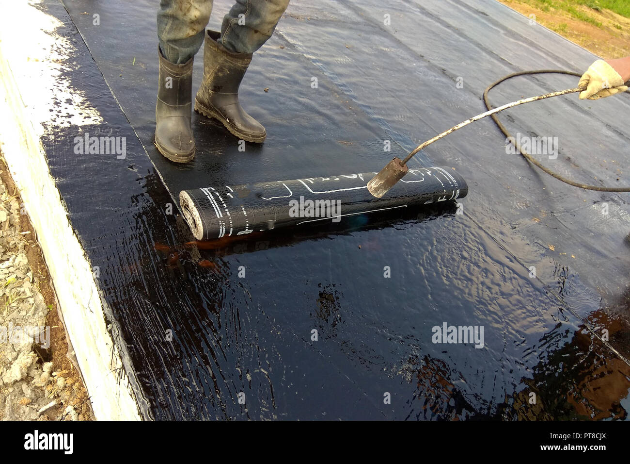 Professional installation of waterproofing on the concrete foundation ...