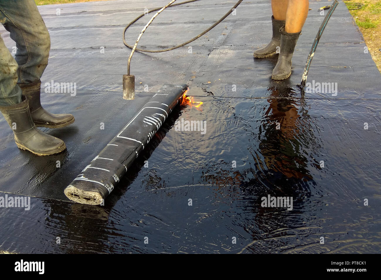 Professional installation of waterproofing on the concrete foundation ...