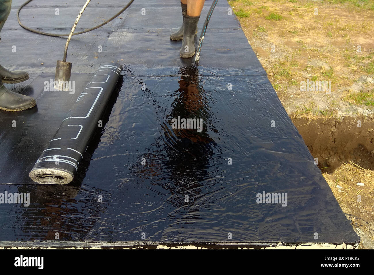 Professional installation of waterproofing on the concrete foundation ...