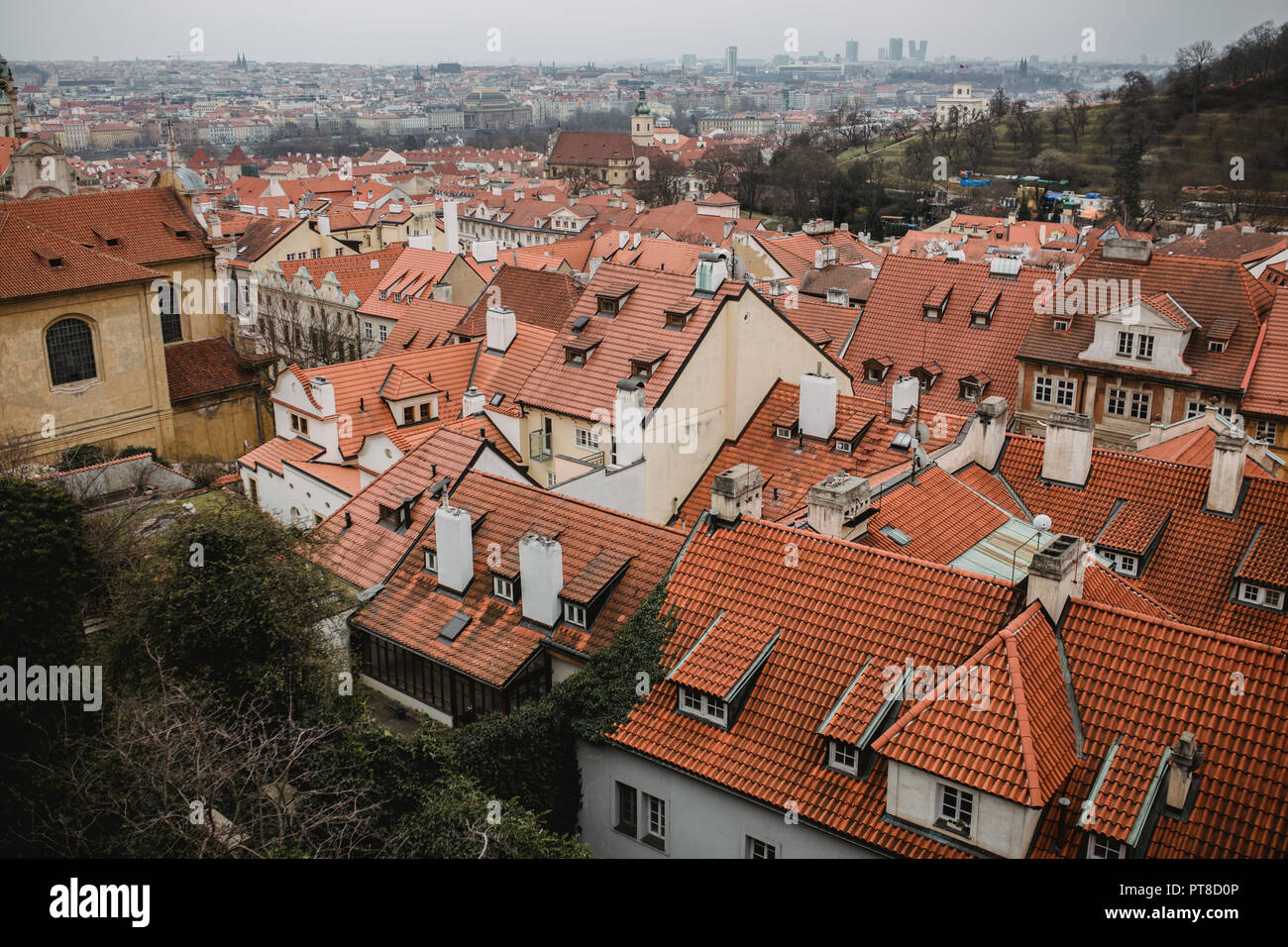 City of Prague with red roofs and Church in fog. City view of Praha old ...