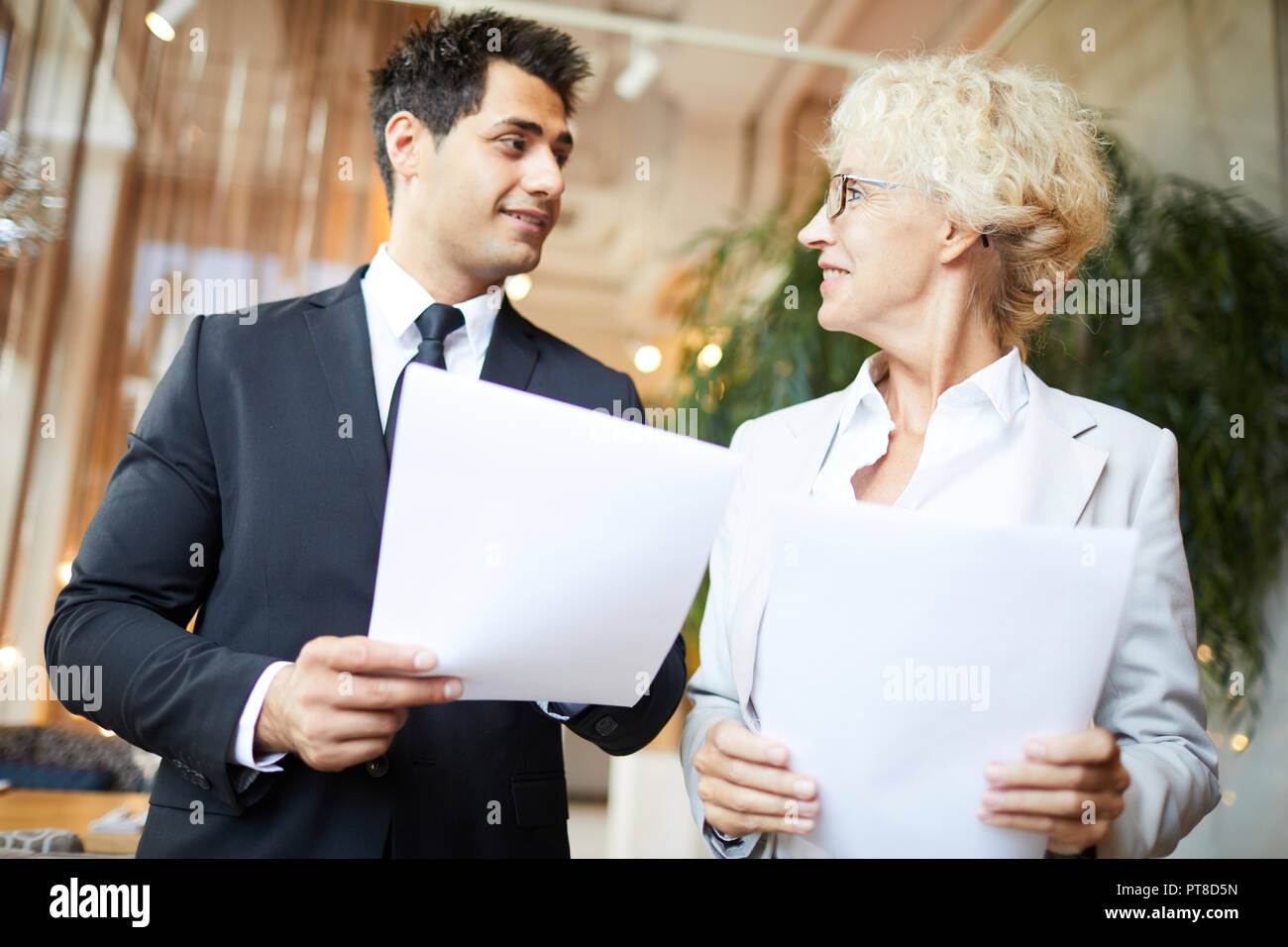 Misunderstanding between business partners: cheerful confident business ...