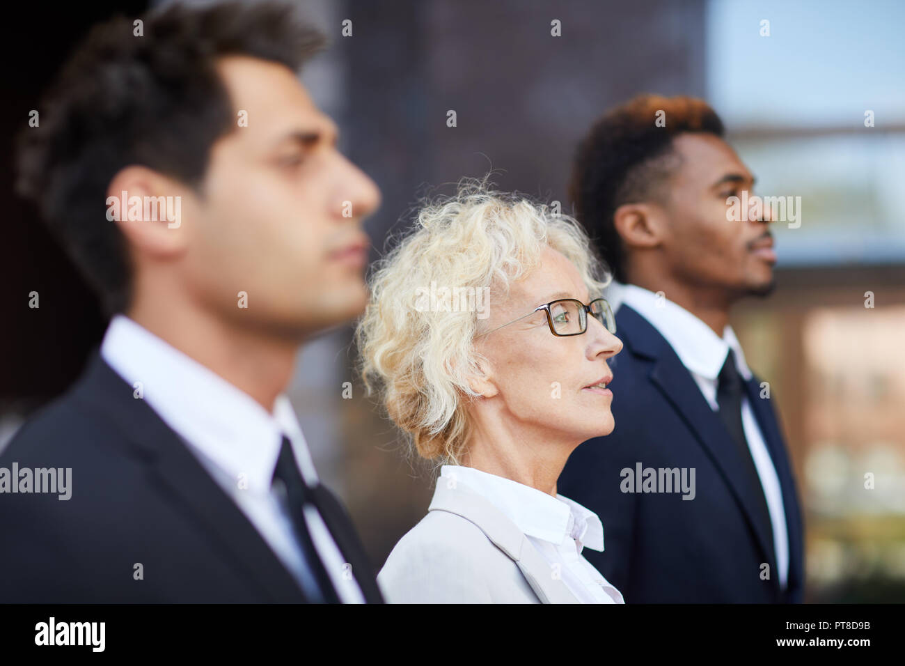 Serious confident purposeful business team looking into distance and ...