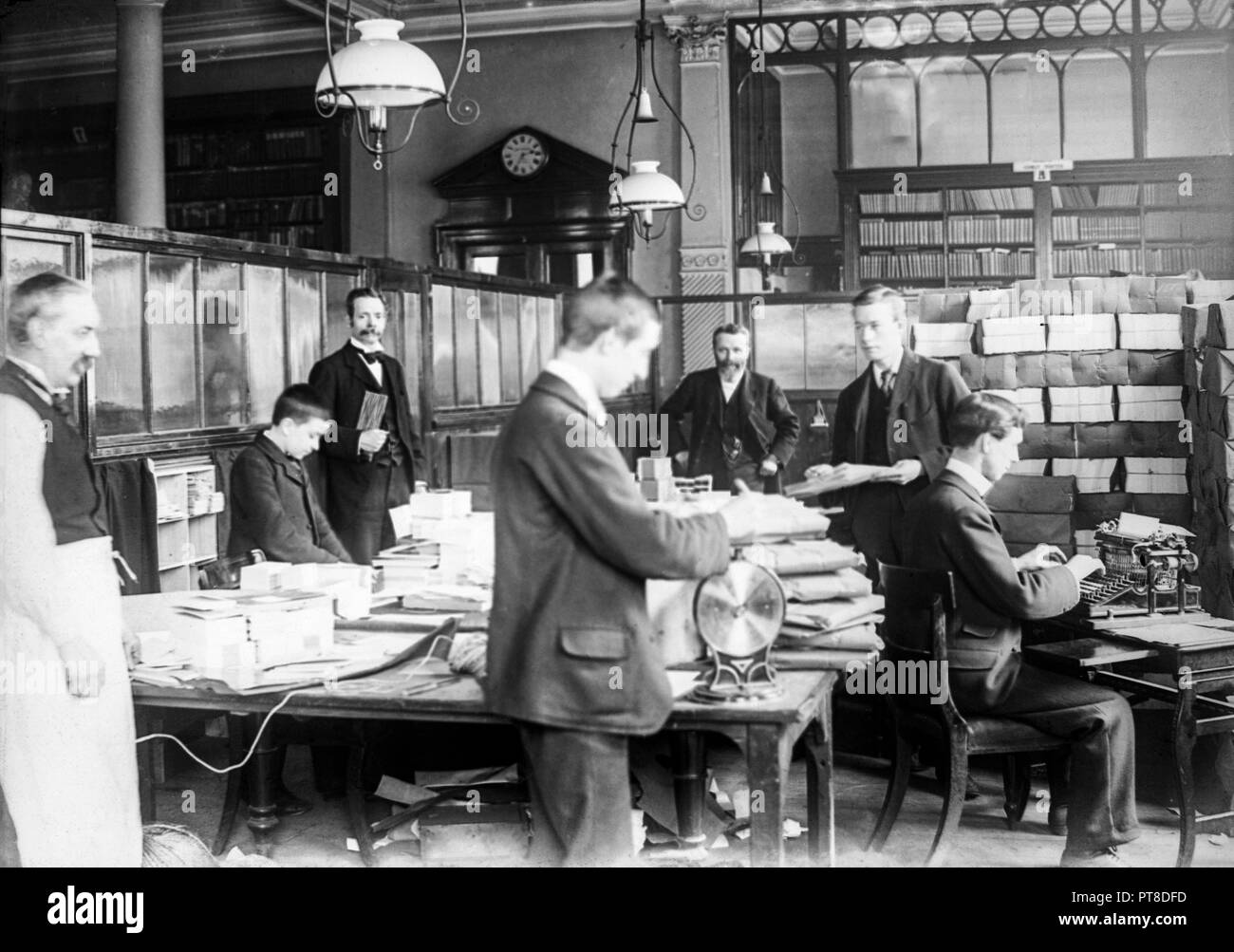 Early twentieth century photograph showing men working in an office ...