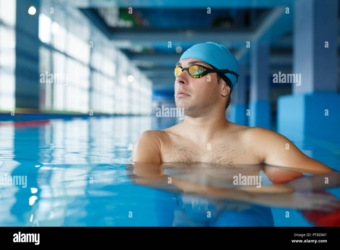 Image of sports swimmer man standing in water at pool during workout ...