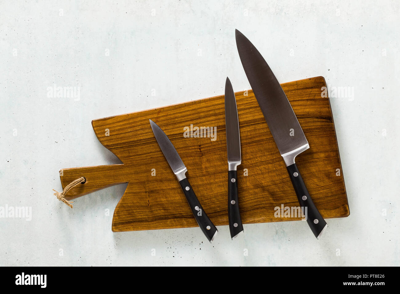 a set of knives on a wooden cutting board Stock Photo - Alamy