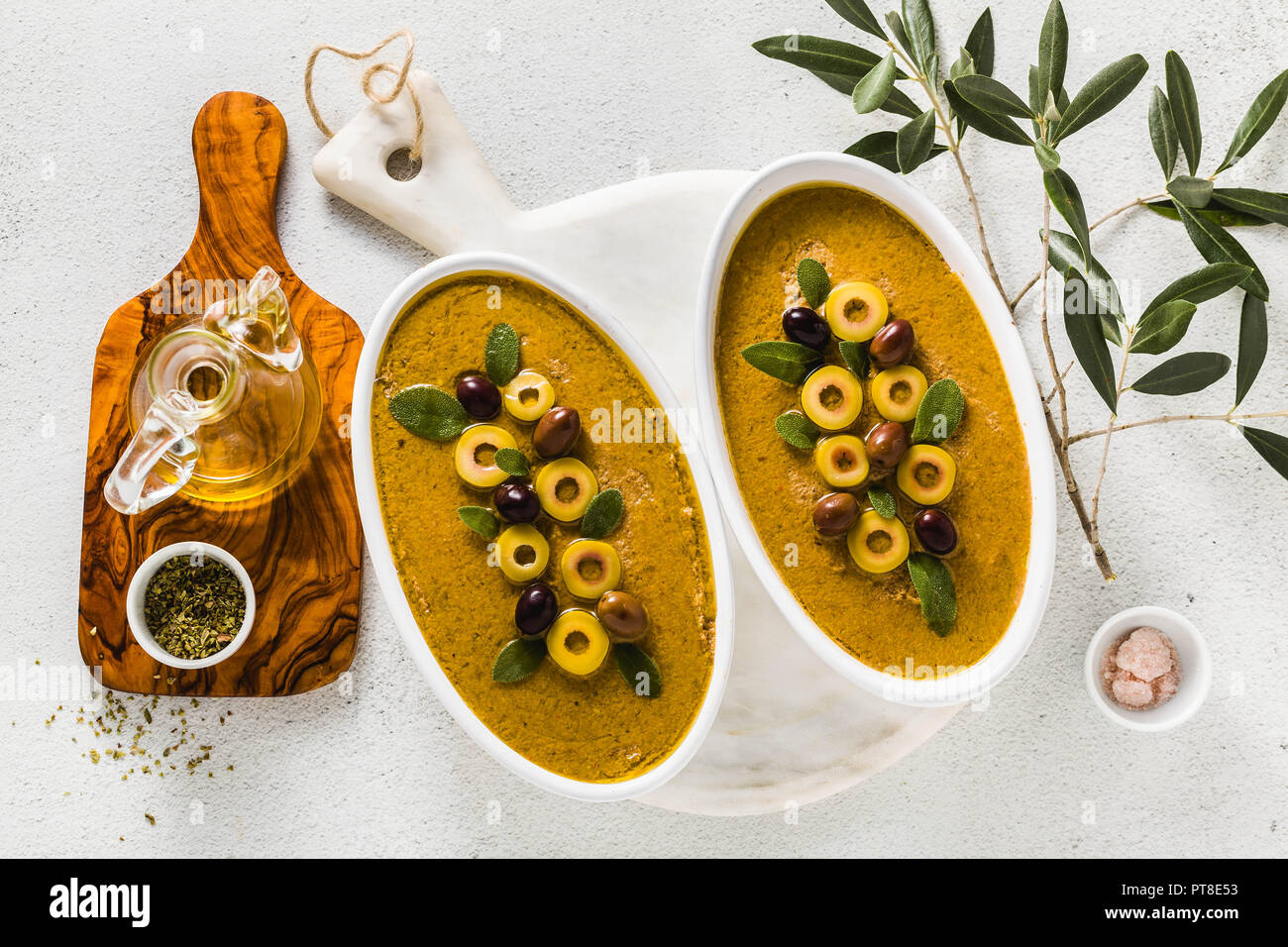 vegan olives pate on a table with a branch of olive tree. healthy vegan ...