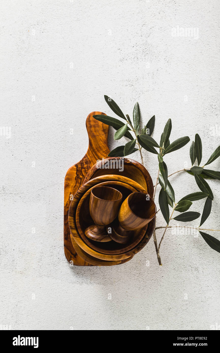 wooden utensils from the olive tree on the white kitchen table and the ...