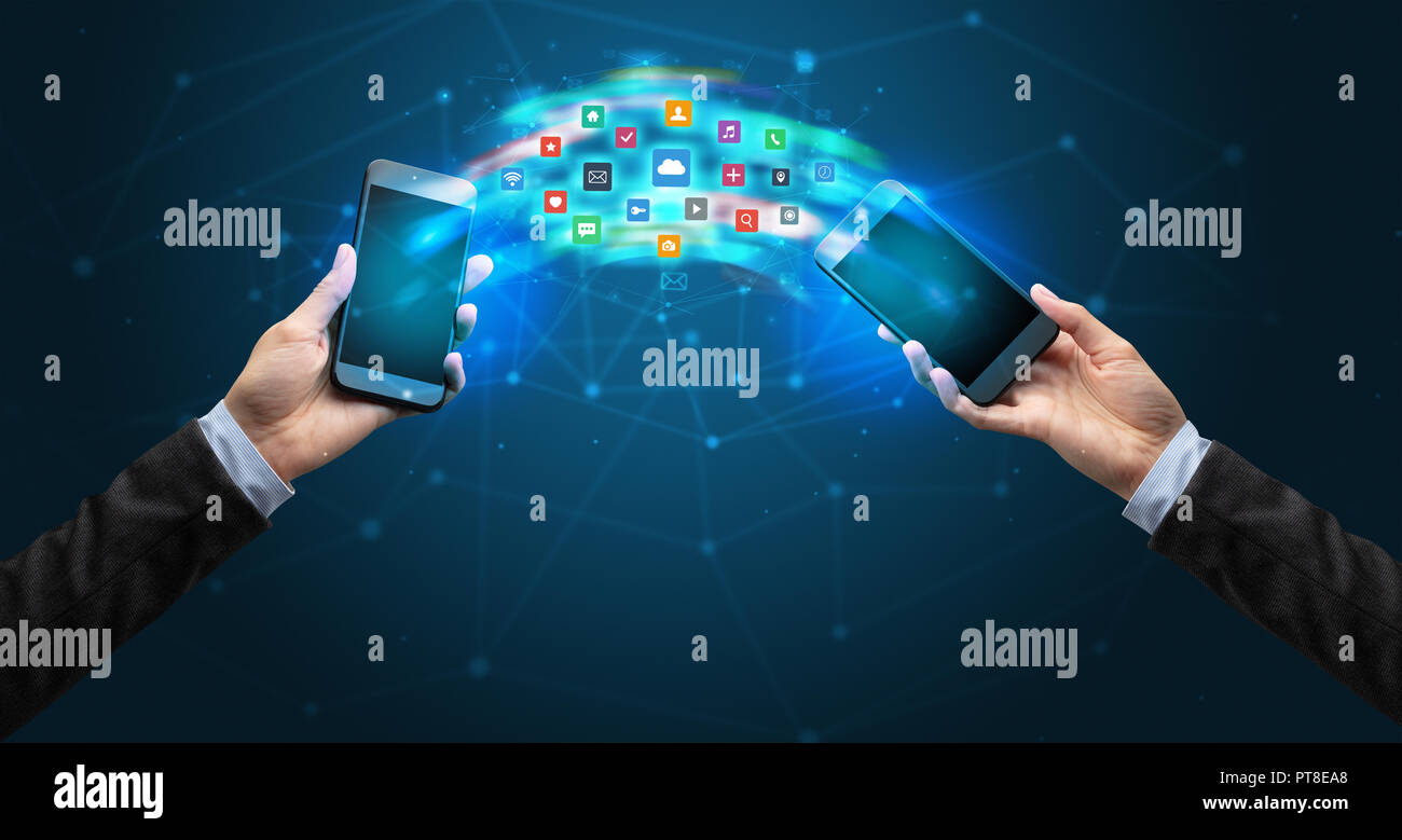 Two mobile phones syncing applications concept Stock Photo - Alamy