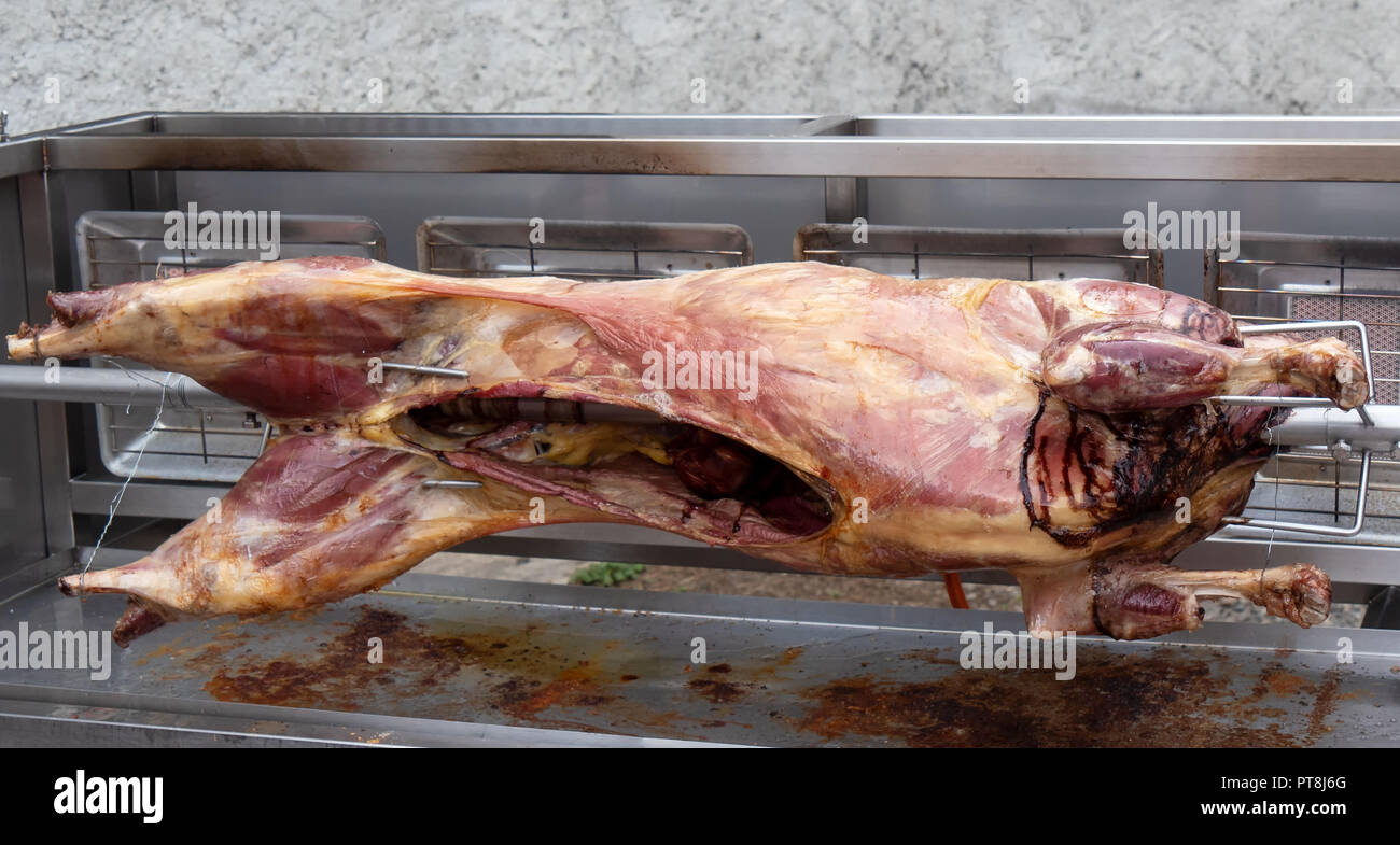 a piglet roasted on a spit Stock Photo - Alamy