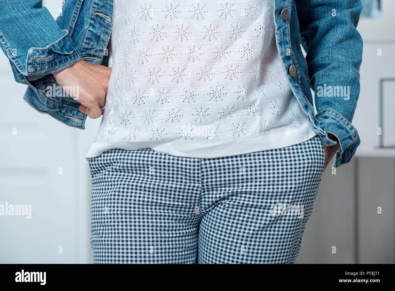 woman with a checkered pants and a jeans jacket Stock Photo - Alamy