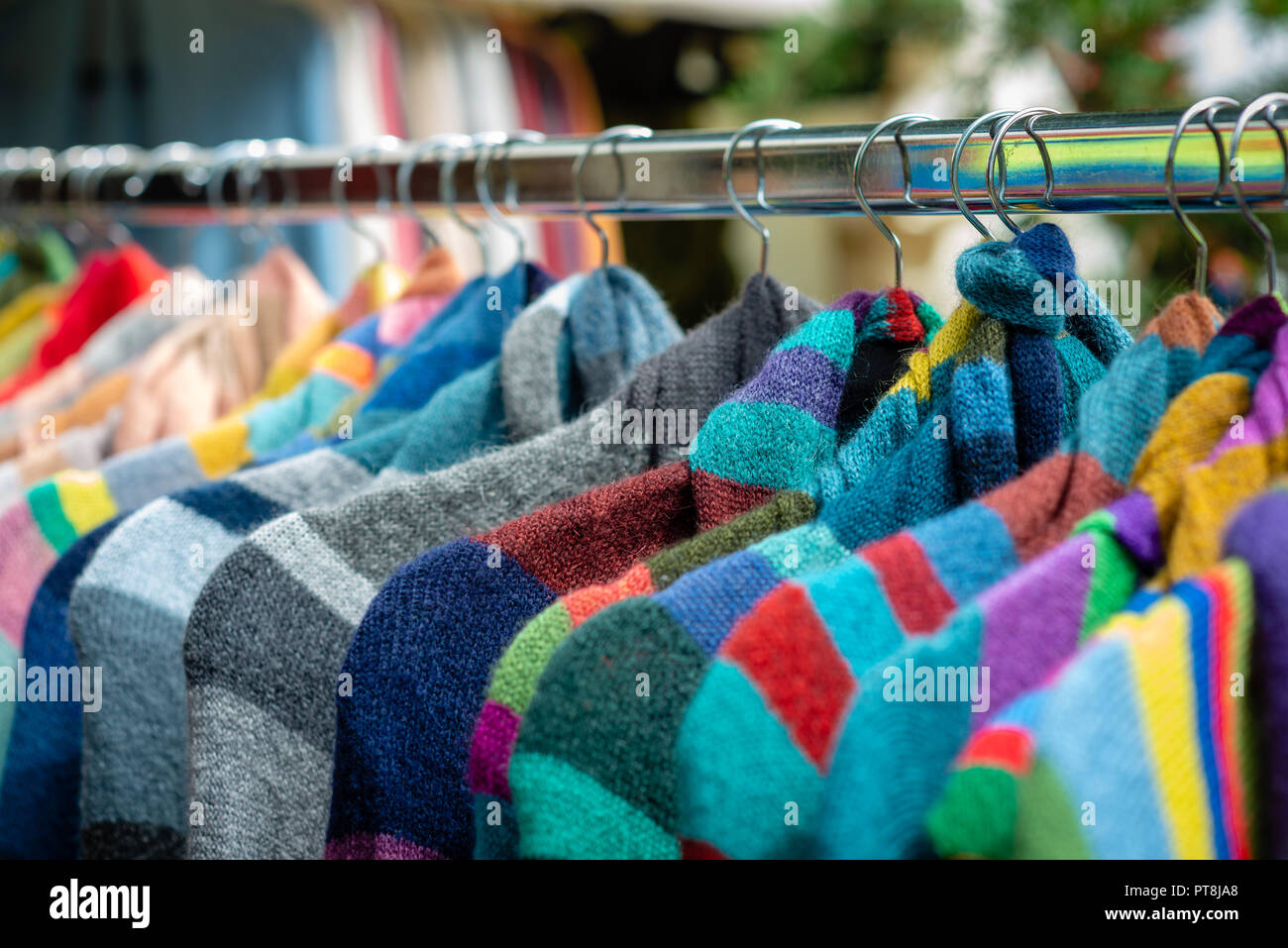 Colorful clothes hang on shelf in a market Stock Photo - Alamy