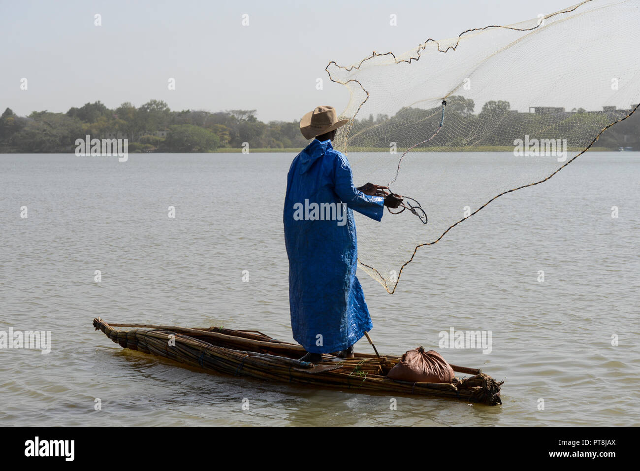 ETHIOPIA , Bahar Dar, lake Tana, fisherman ejecting fishing net from ...