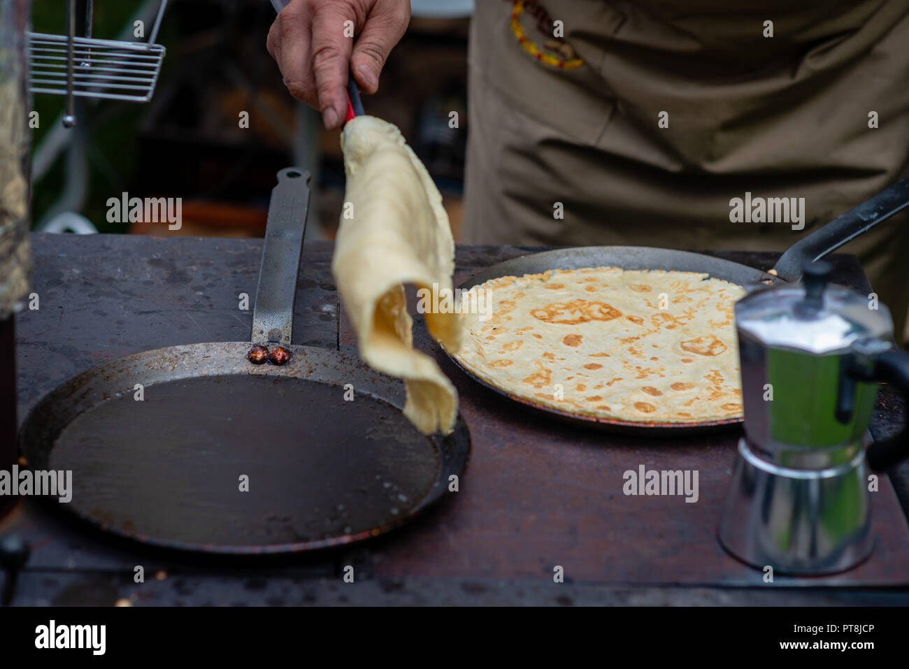A man in an open-air picnic baked pancakes Stock Photo - Alamy